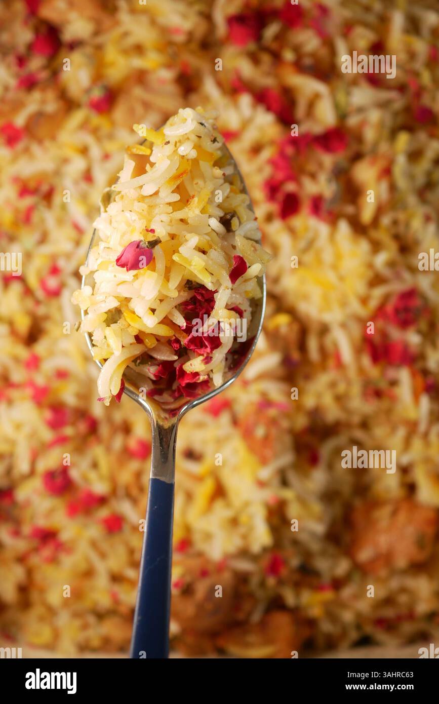 Delicious biryani served on a spoon with vibrant toppings Stock Photo ...