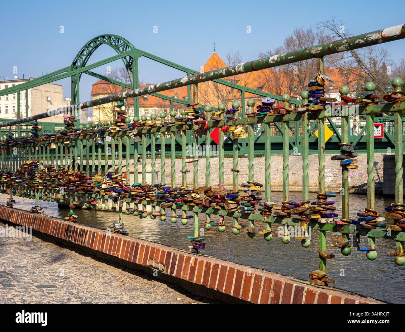 A sturdy bridge adorned with an abundance of colorful locks attached to ...