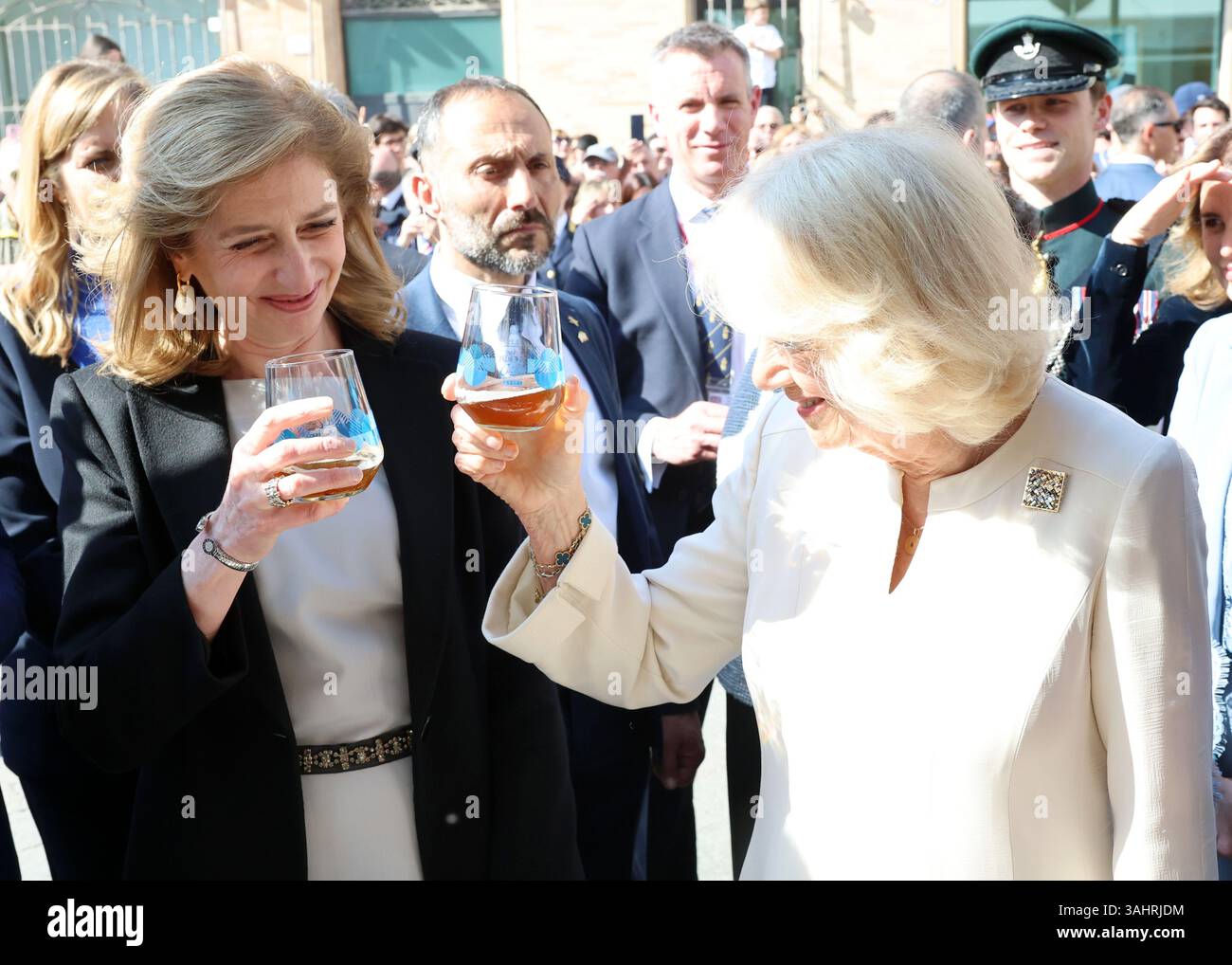Queen Camilla samples a drink with First Lady of Italy Laura Mattarella ...