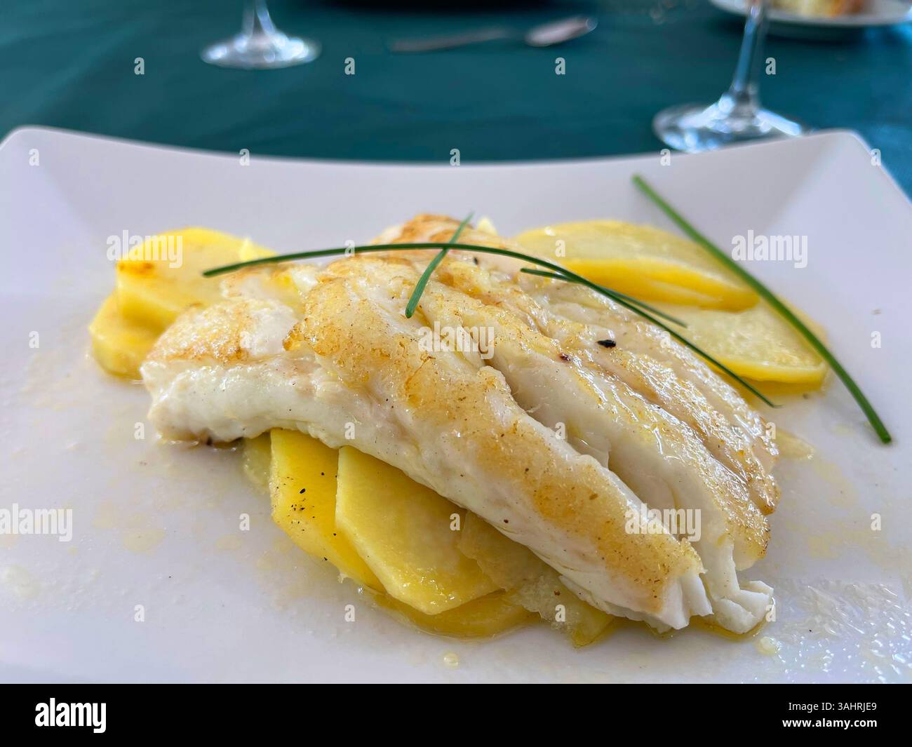 Grilled hake loin with potatoes and chives. Spain Stock Photo - Alamy