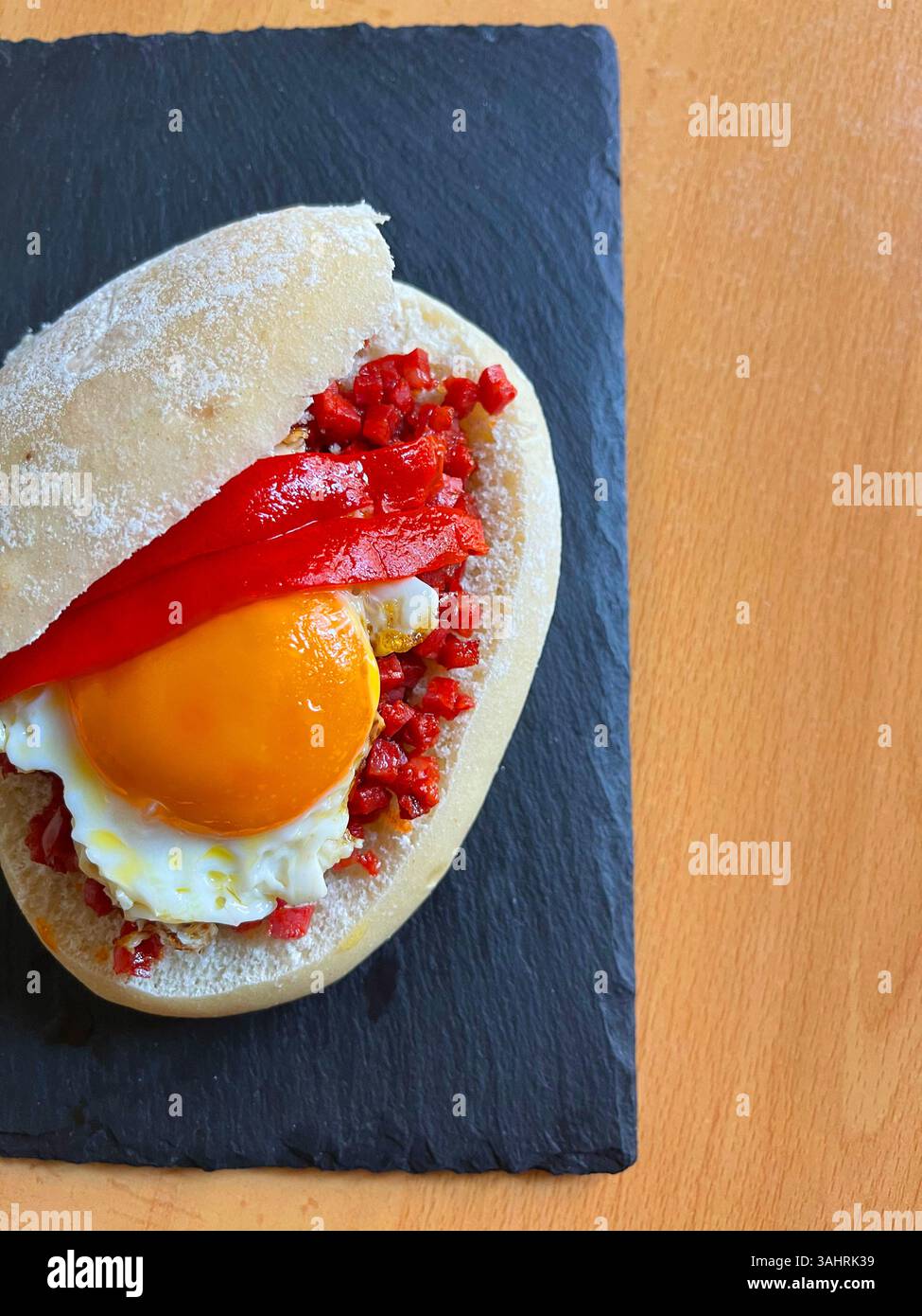 Tapa made of picadillo, fried egg and red pepper in bread. Spain Stock ...