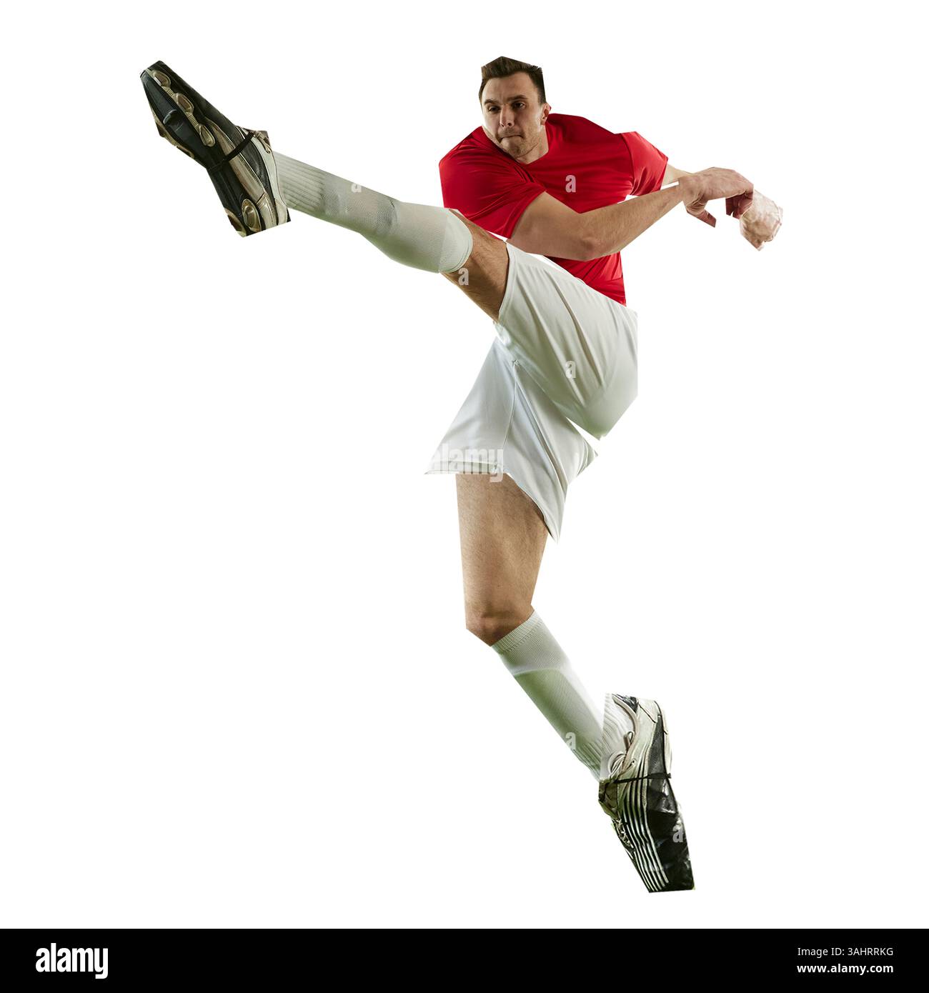 Focused man, soccer player in red shirt and white shorts captured in ...