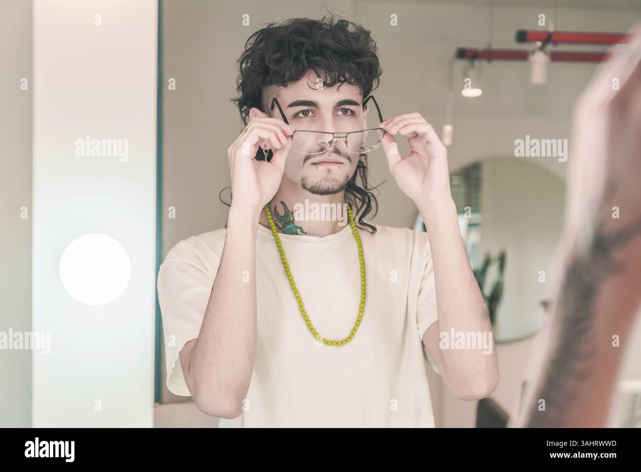 Stylish man adjusting eyeglasses hi-res stock photography and images ...