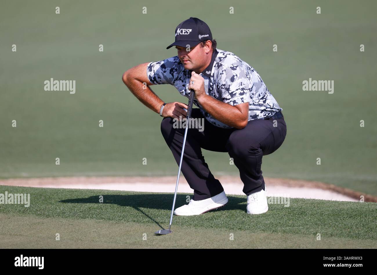 Patrick Reed lines up a putt on the second hole during the first round ...