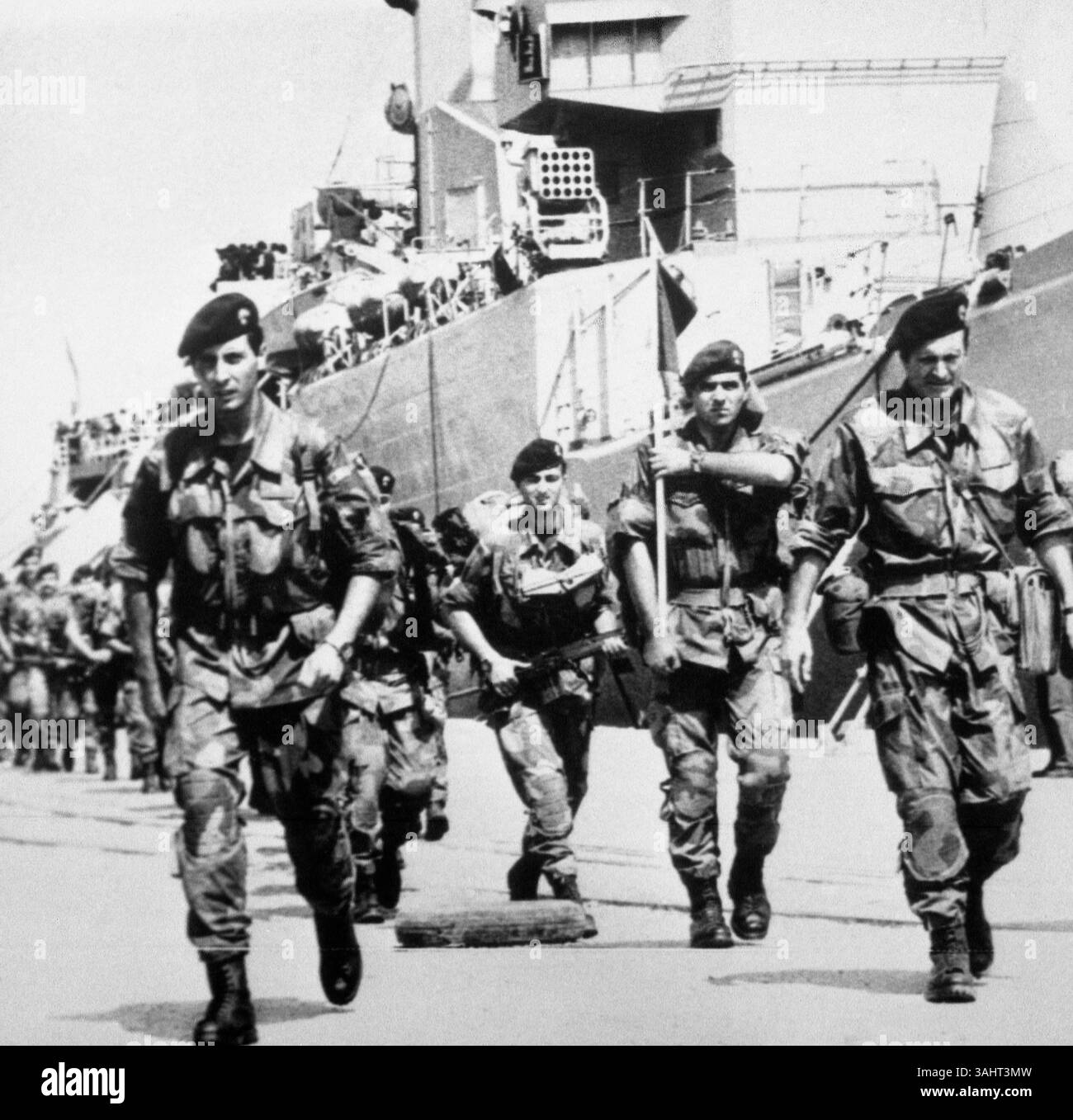 Italian marine and paratroop battalions marching off their ships ...