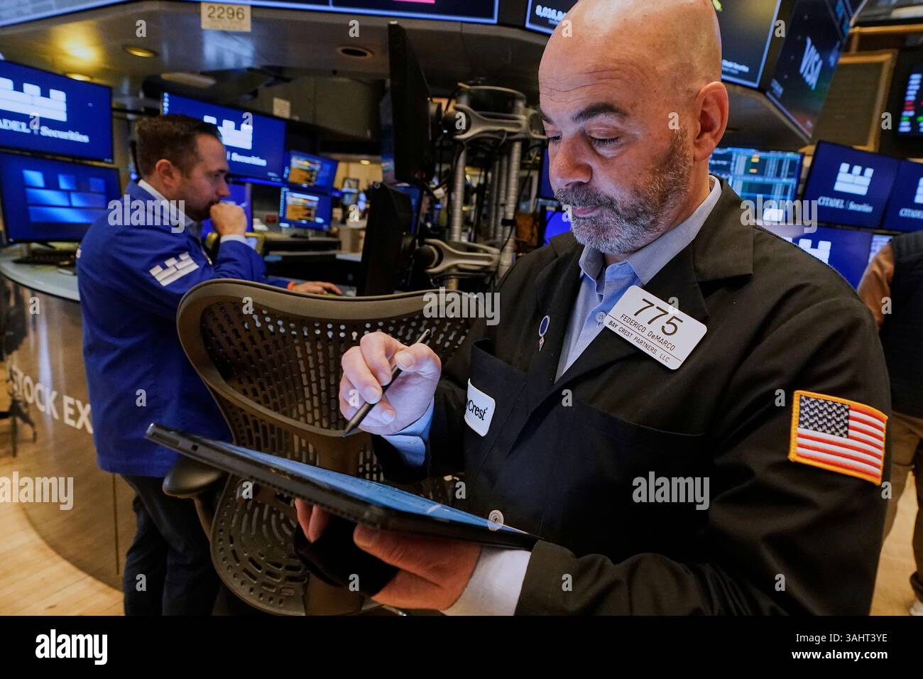 Trader Fred Demarco, right, works on the floor of the New York Stock ...