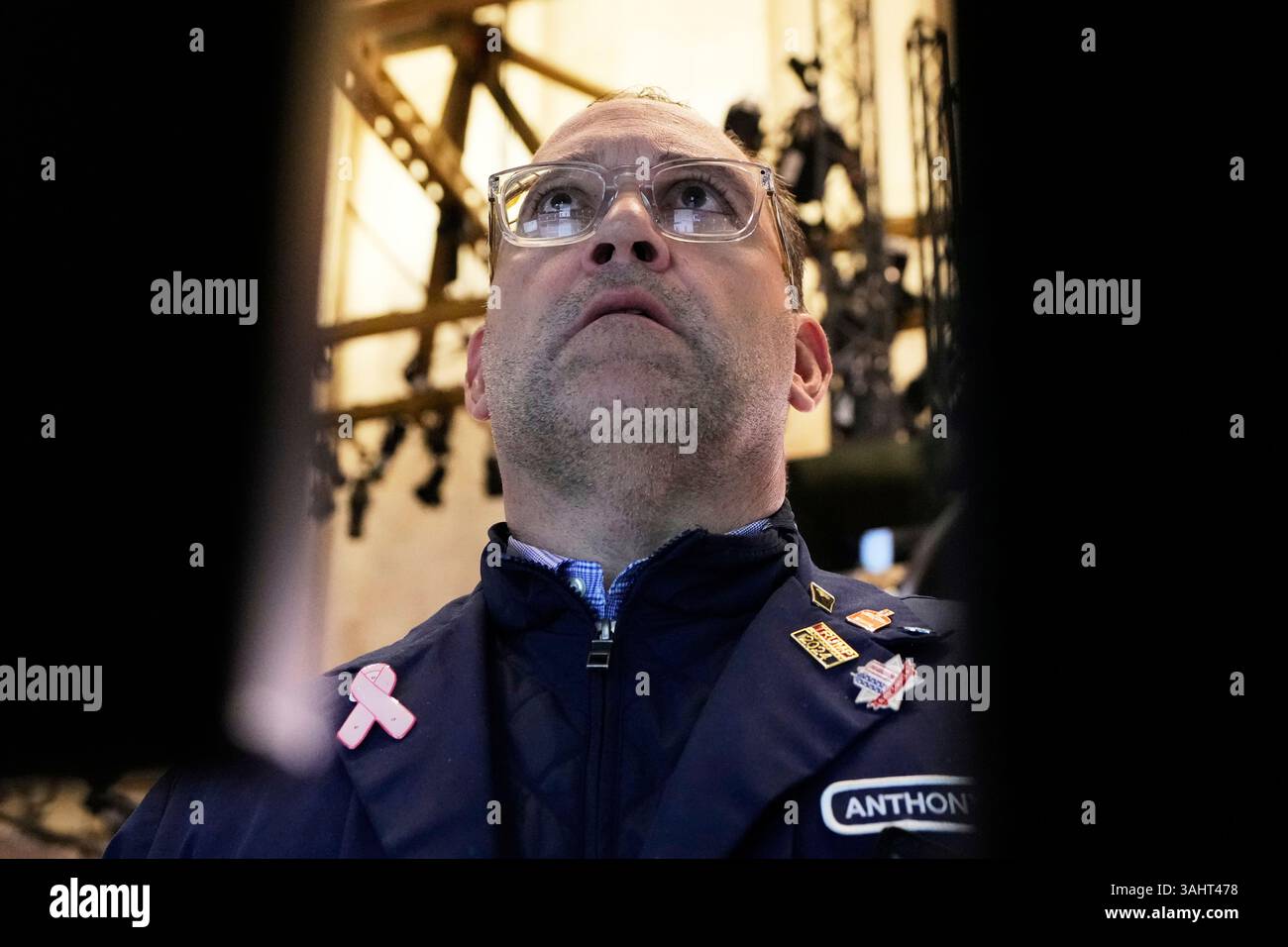 Specialist Anthony Matesic is framed by his monitors as he works at his ...