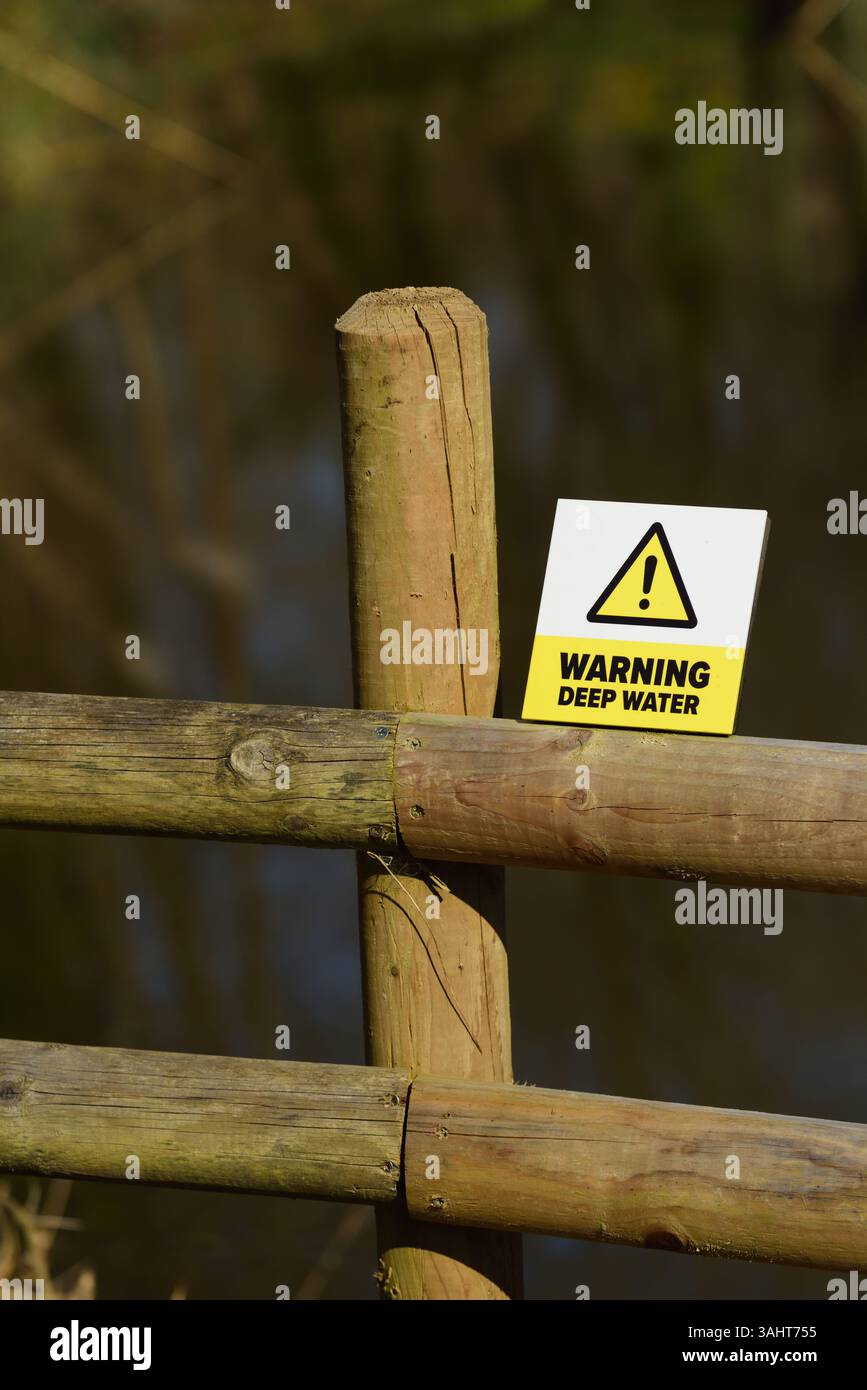 A warning sign beside a pond at Paignton zoo Stock Photo - Alamy
