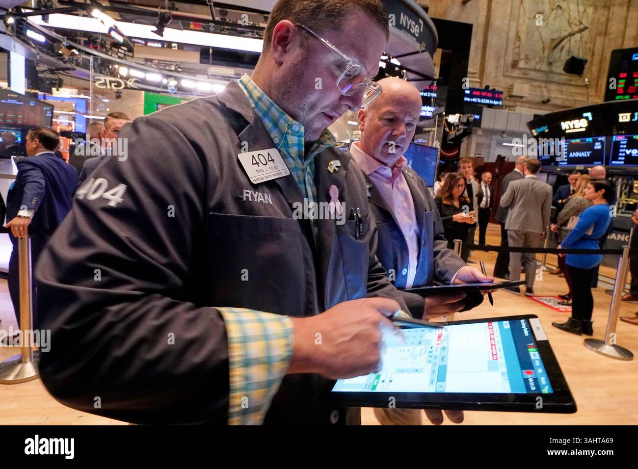 Traders Ryan Falvey, left, and Patrick Casey work on the floor of the ...