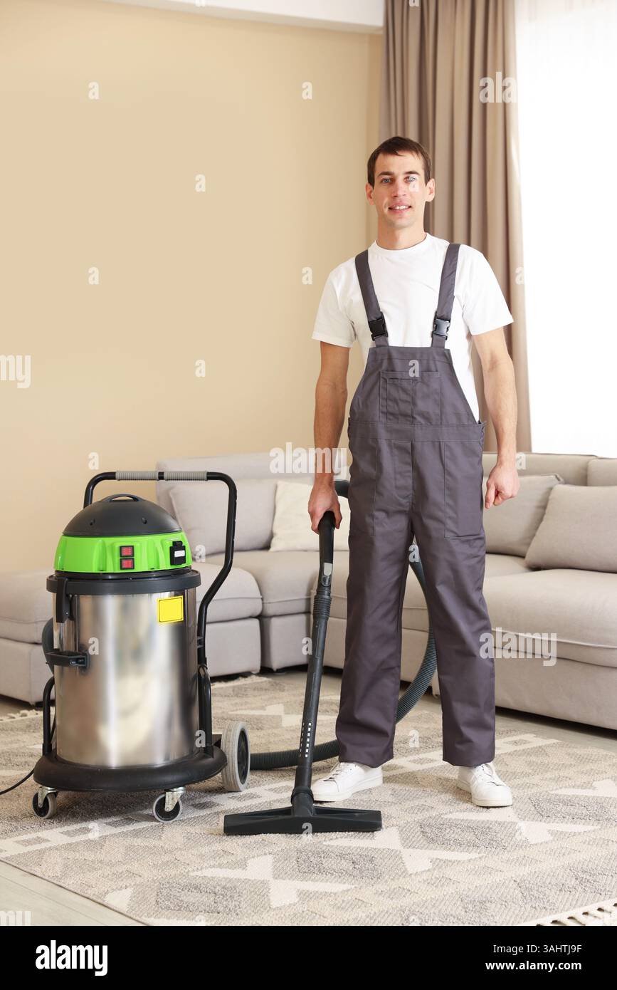 Cleaning service worker with professional vacuum cleaner indoors Stock ...