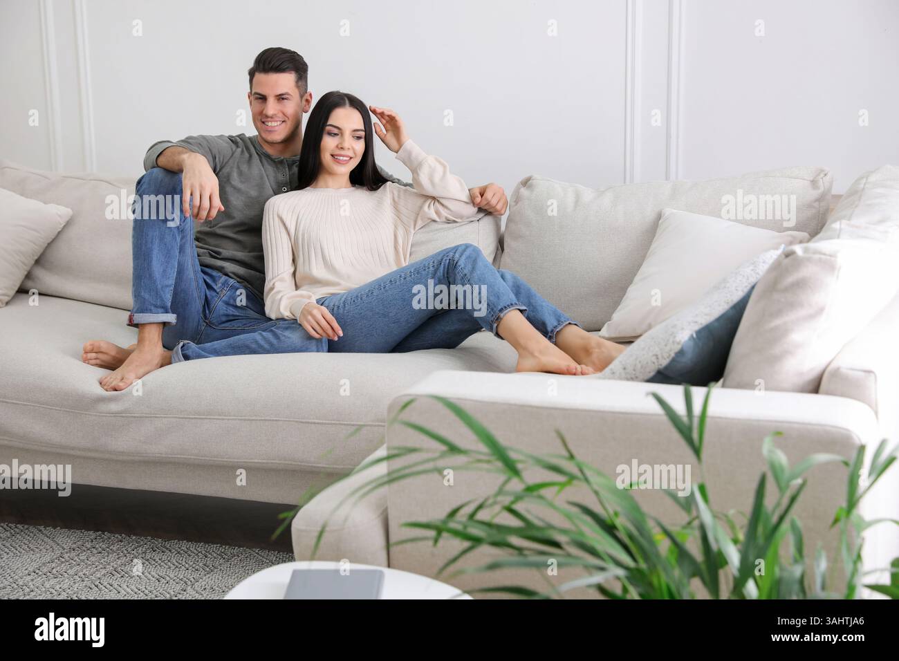 Couple resting on sofa hi-res stock photography and images - Alamy