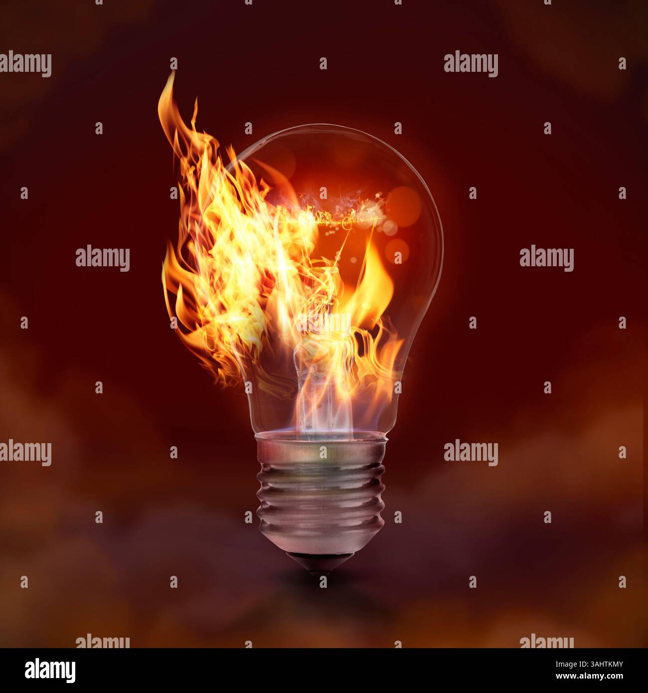 Idea concept. Light bulb with flames surrounded by smoke on dark red ...