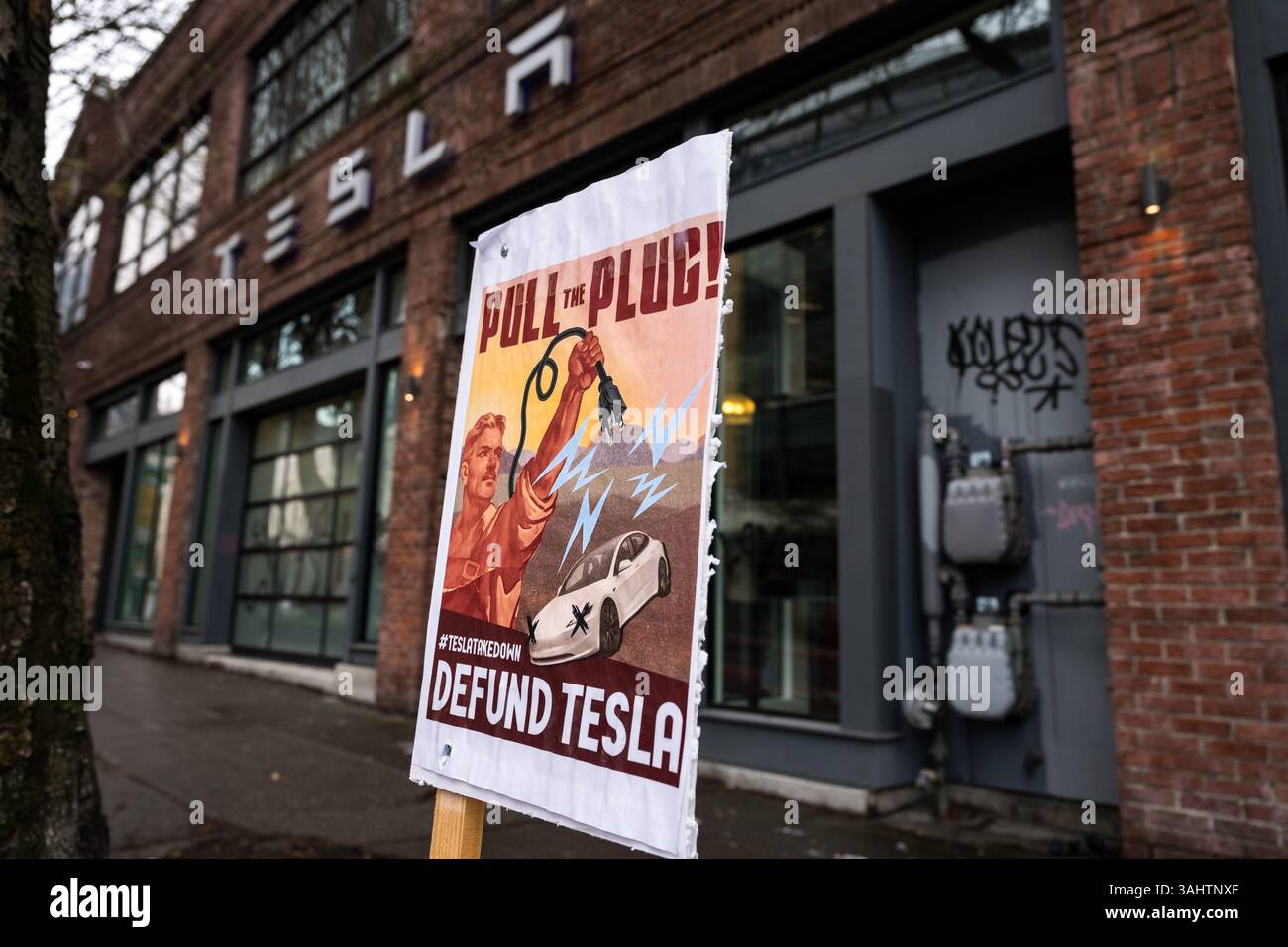Seattle, USA. 24th Mar 2025. A defund Tesla take down sign at the ...