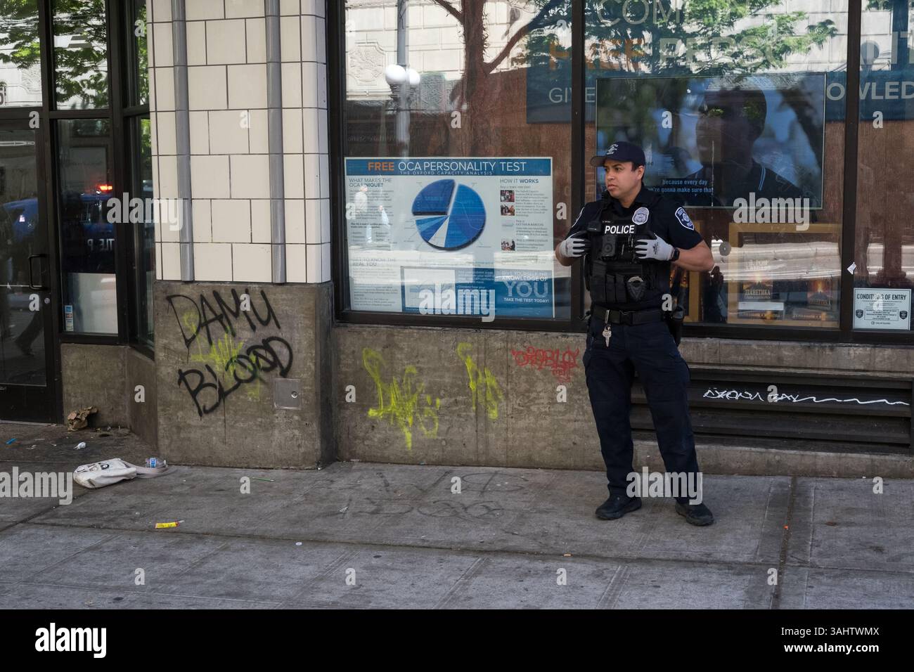 Seattle, USA. 22nd Apr 2024. A police officer standing next to a Damu ...