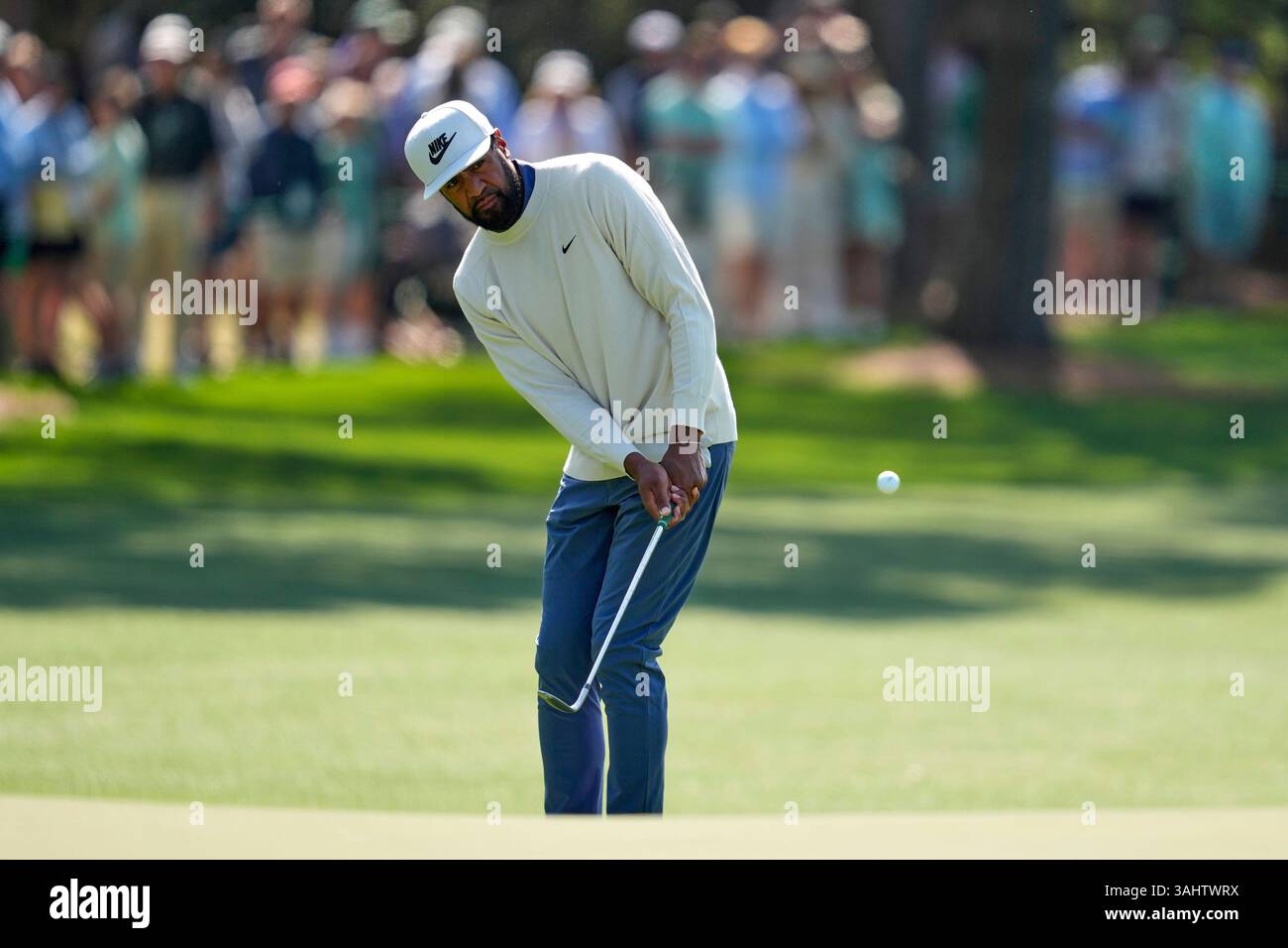 Tony Finau chips to the green on the first hole during the first round ...