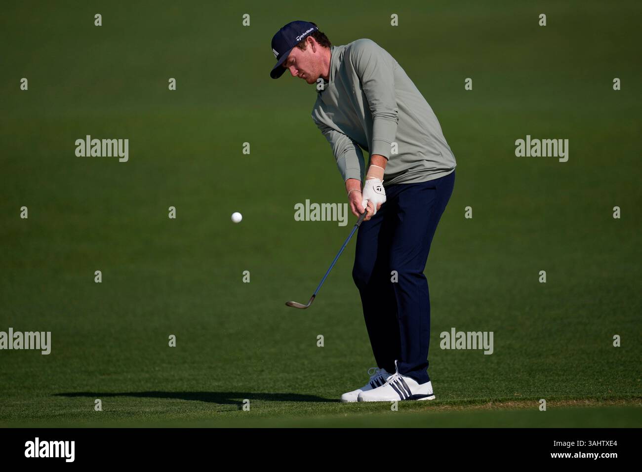 Nick Dunlap chips to the green on the second hole during the first ...