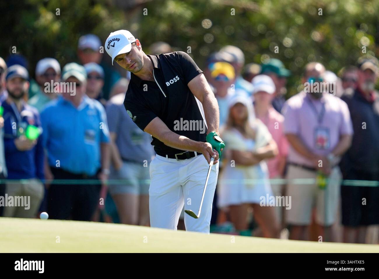 Thomas Detry, of Belgium, chips to the green on the first hole during the first round at the ...