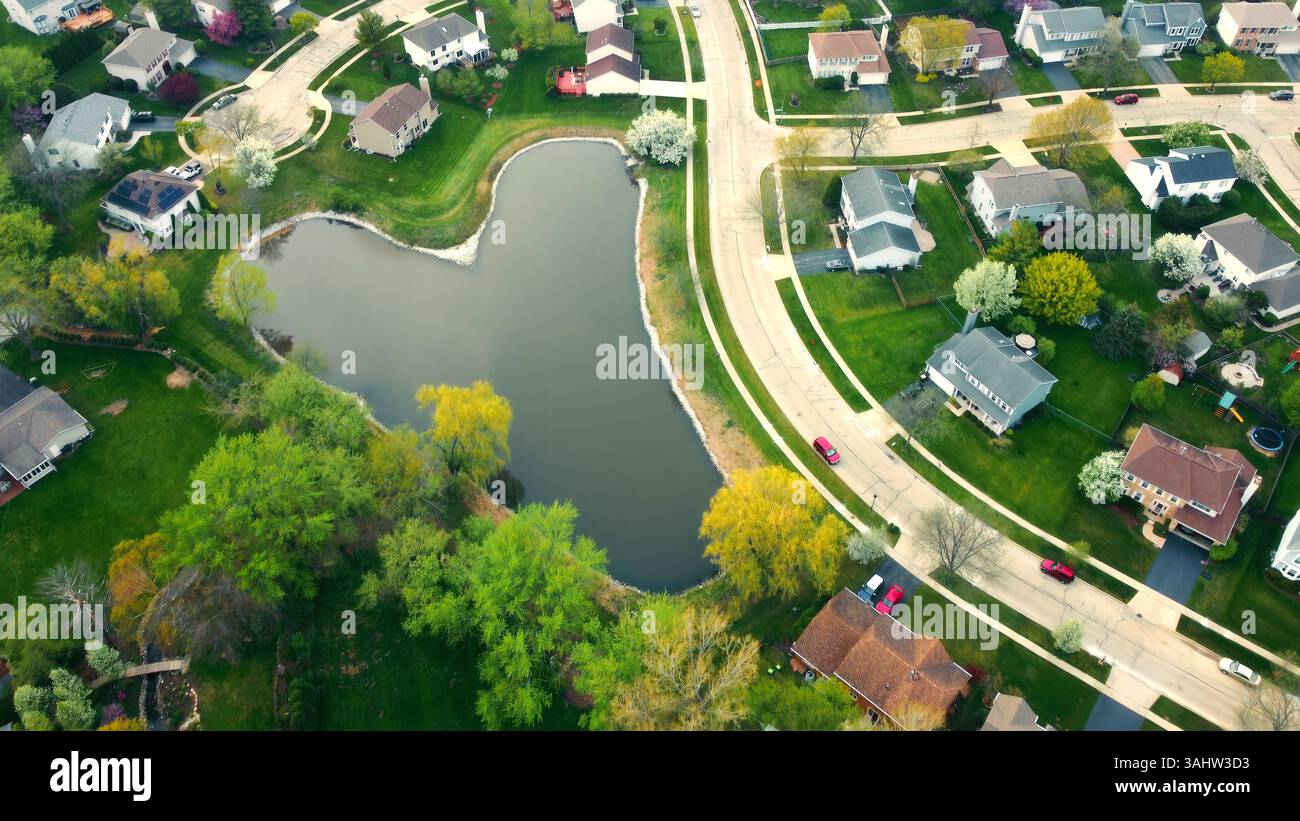 Aerial view of suburban neighborhood with heart-shaped pond. Aerial ...