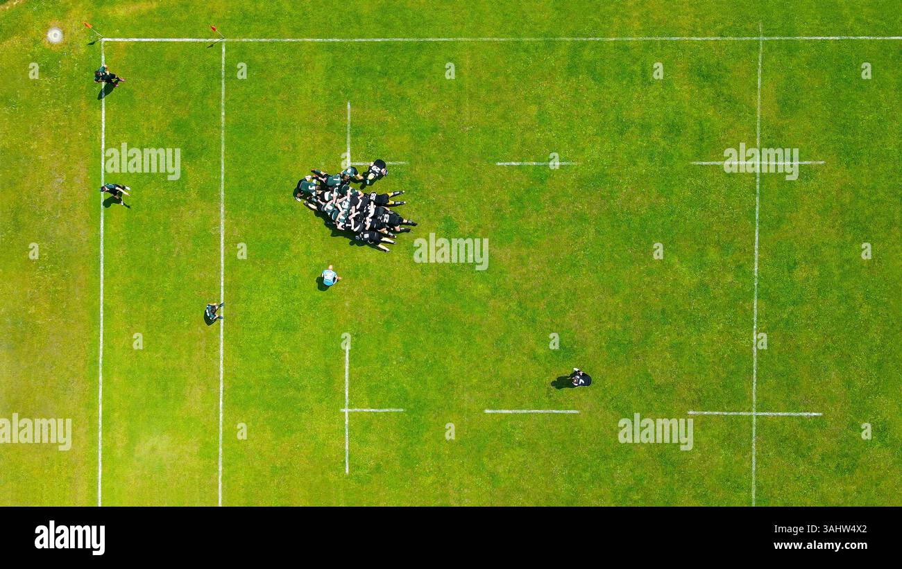 Aerial View of Rugby Scrum on Green Field. A top-down aerial view of a ...