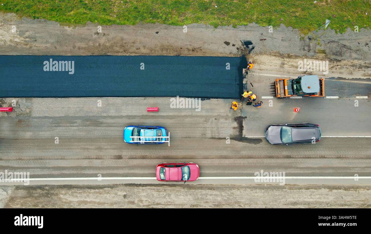 Aerial View of Road Paving with Traffic Nearby. Aerial shot of workers ...