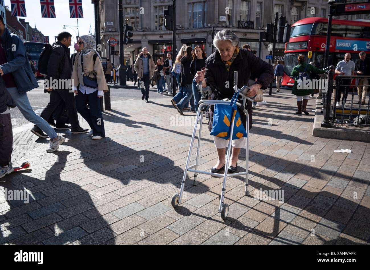 Elderly walking frame busy street hi-res stock photography and images ...