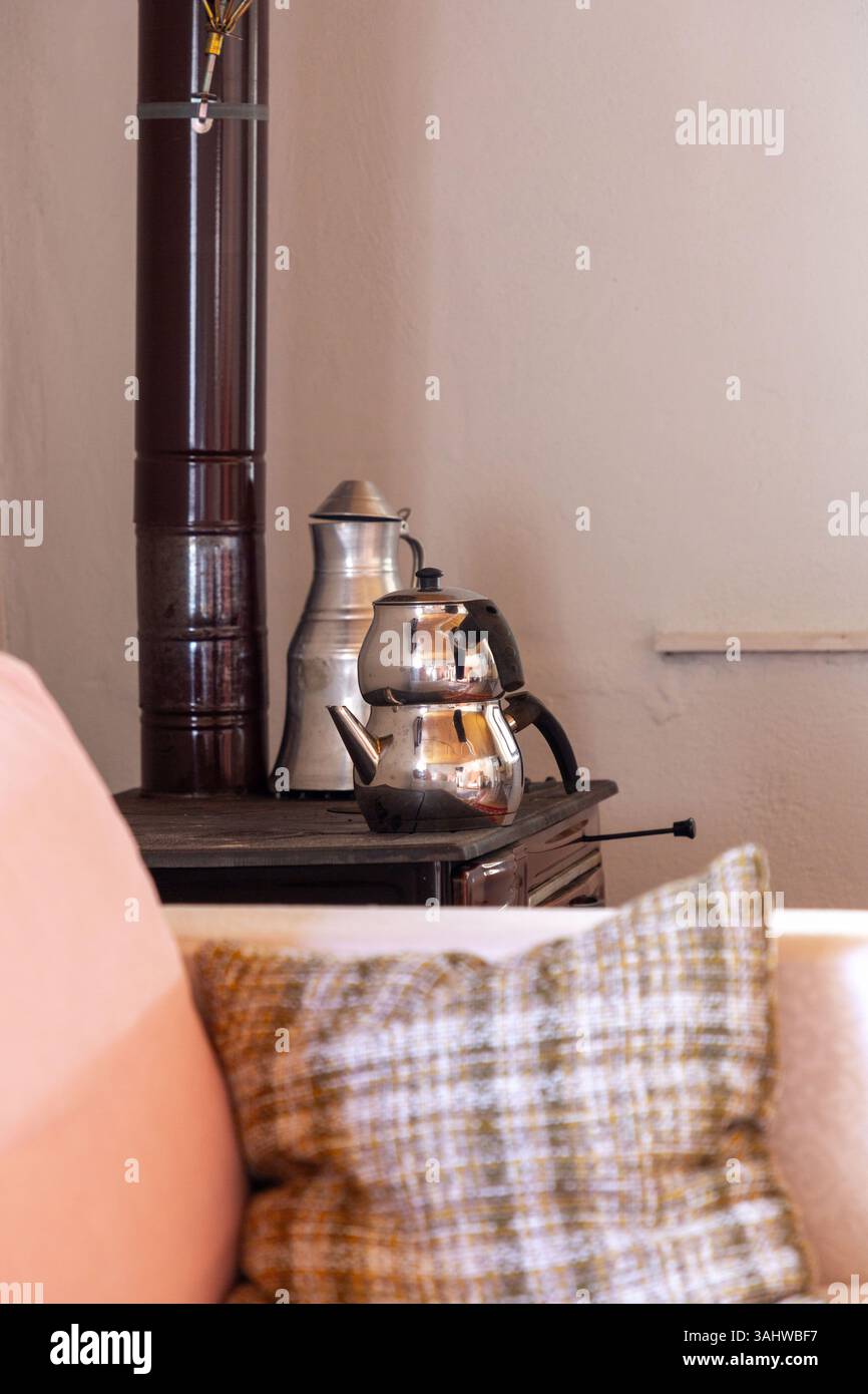 Turkish tea pot warming on top of a wood stove in a traditional Turkish ...
