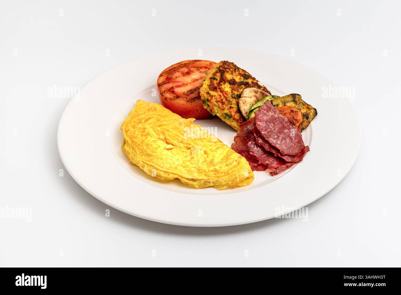 Rustic breakfast plate with fried eggs, grilled vegetables, and turkey ...