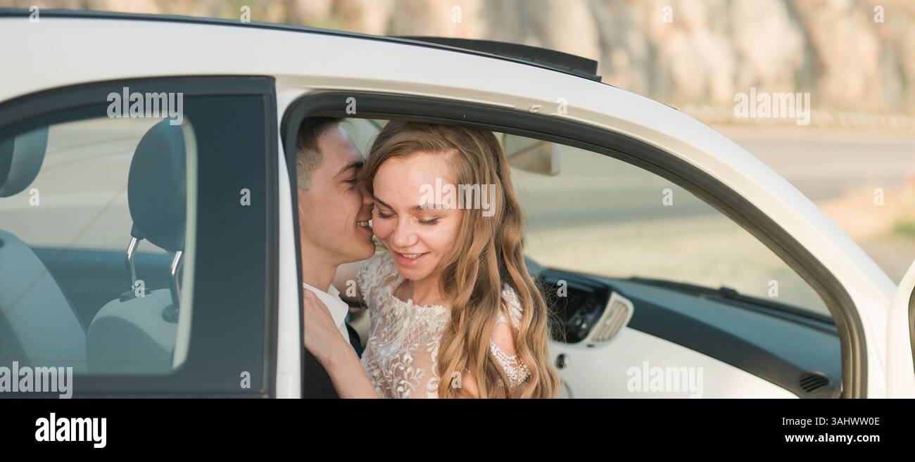 Banner couple shares tender moment in parked car during sunset, copy ...