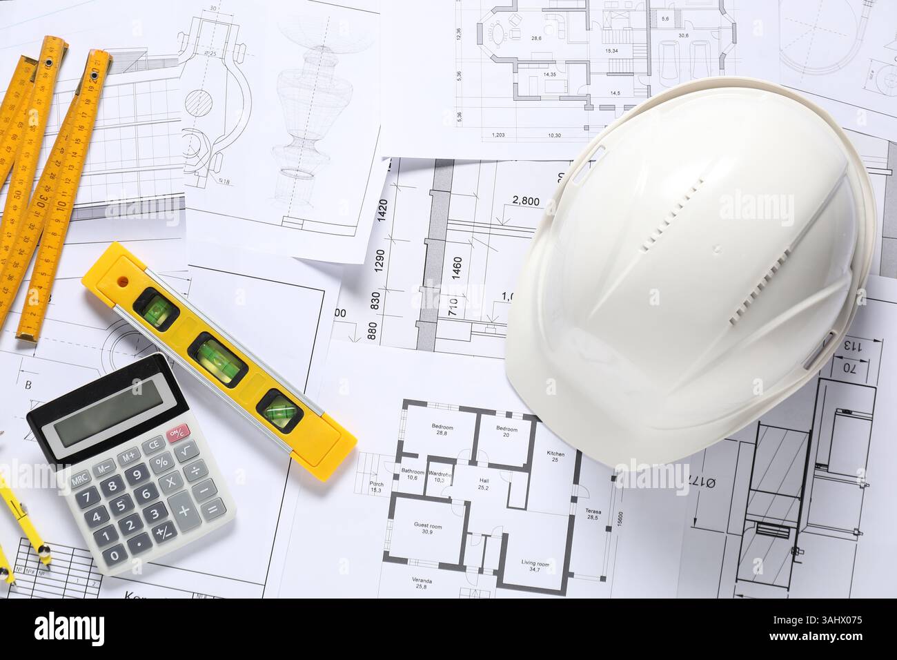 Hard hat, divider, calculator, folding ruler and building level on ...