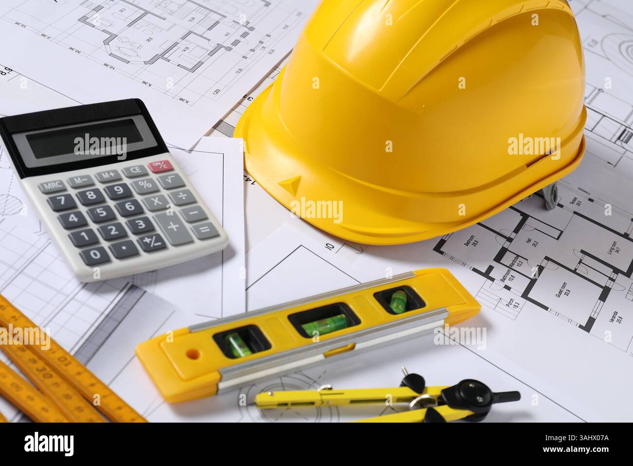 Hard hat, divider, calculator, folding ruler and building level on ...