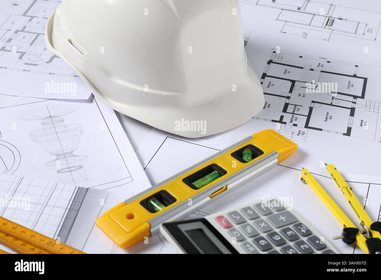 Hard hat, divider, calculator, folding ruler and building level on ...
