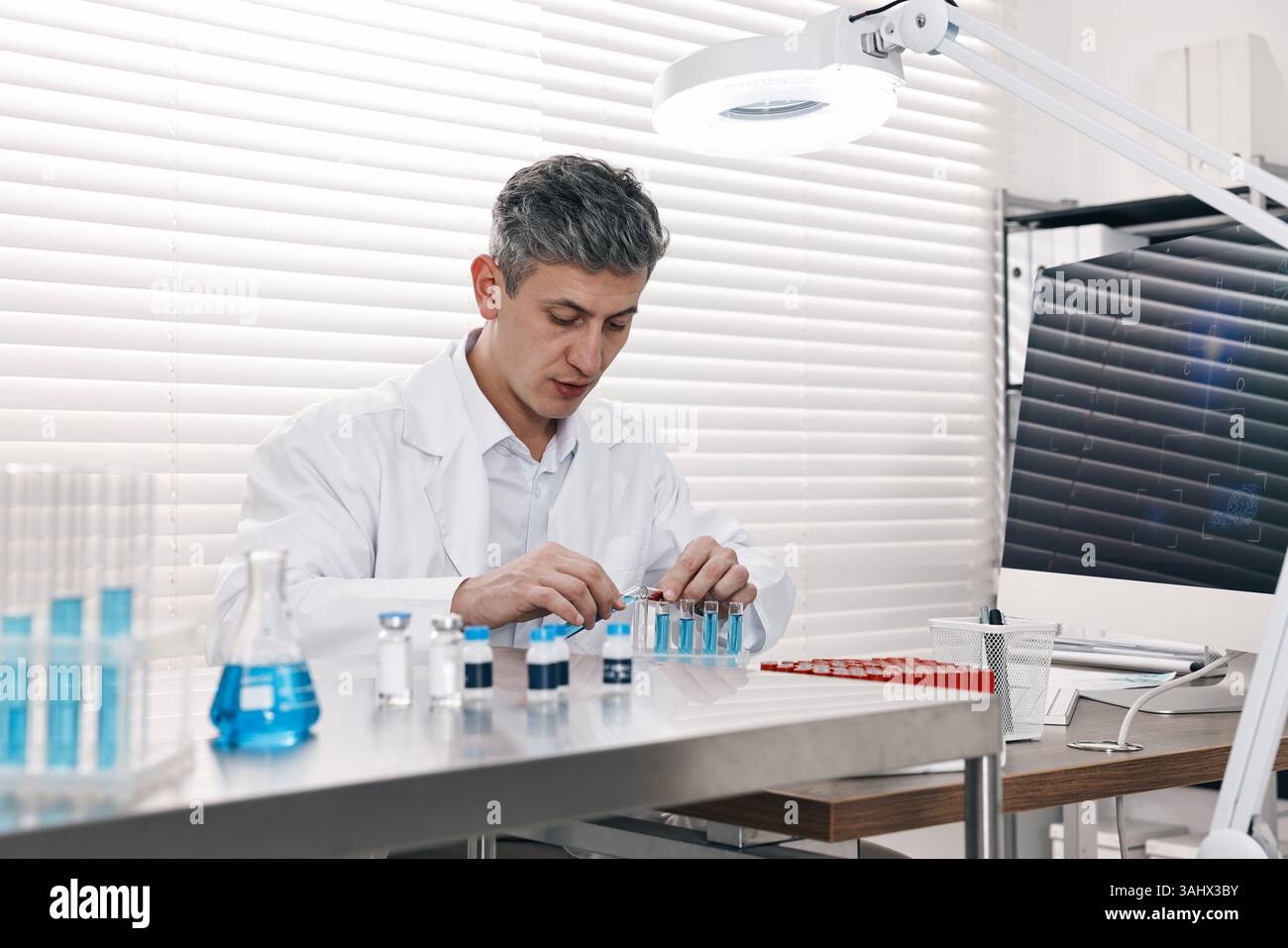 Scientist with test tubes working in laboratory Stock Photo - Alamy