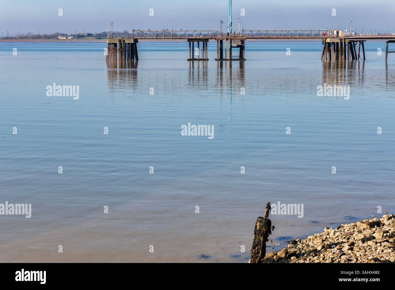 A pier over the river thames viewed from the Cliffe RSPB nature reserve ...