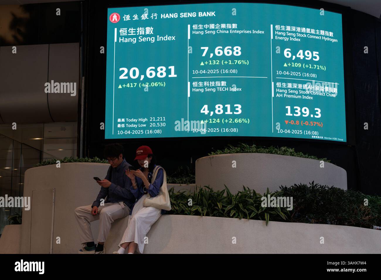 Hong Kong, China. 10th Apr, 2025. People look at their phone under the ...