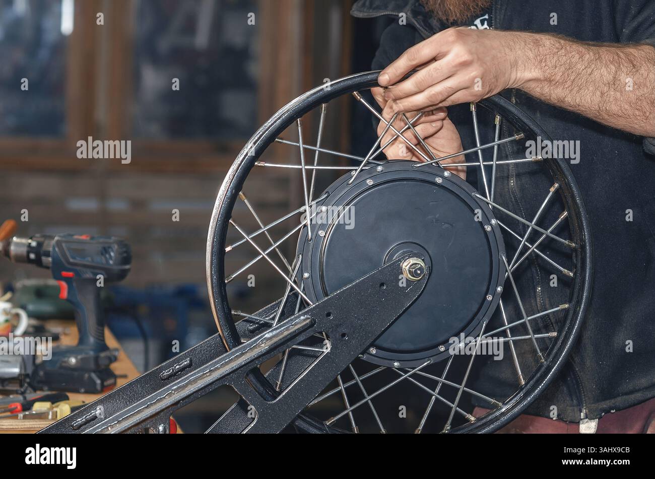 Bicycle mechanic disassembles wheel with an electric motor. Electric ...
