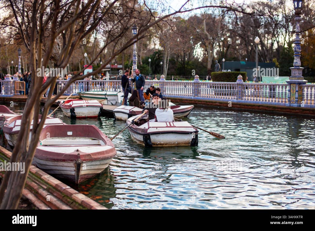 Scenic boat tour with people in Seville Spain Stock Photo - Alamy