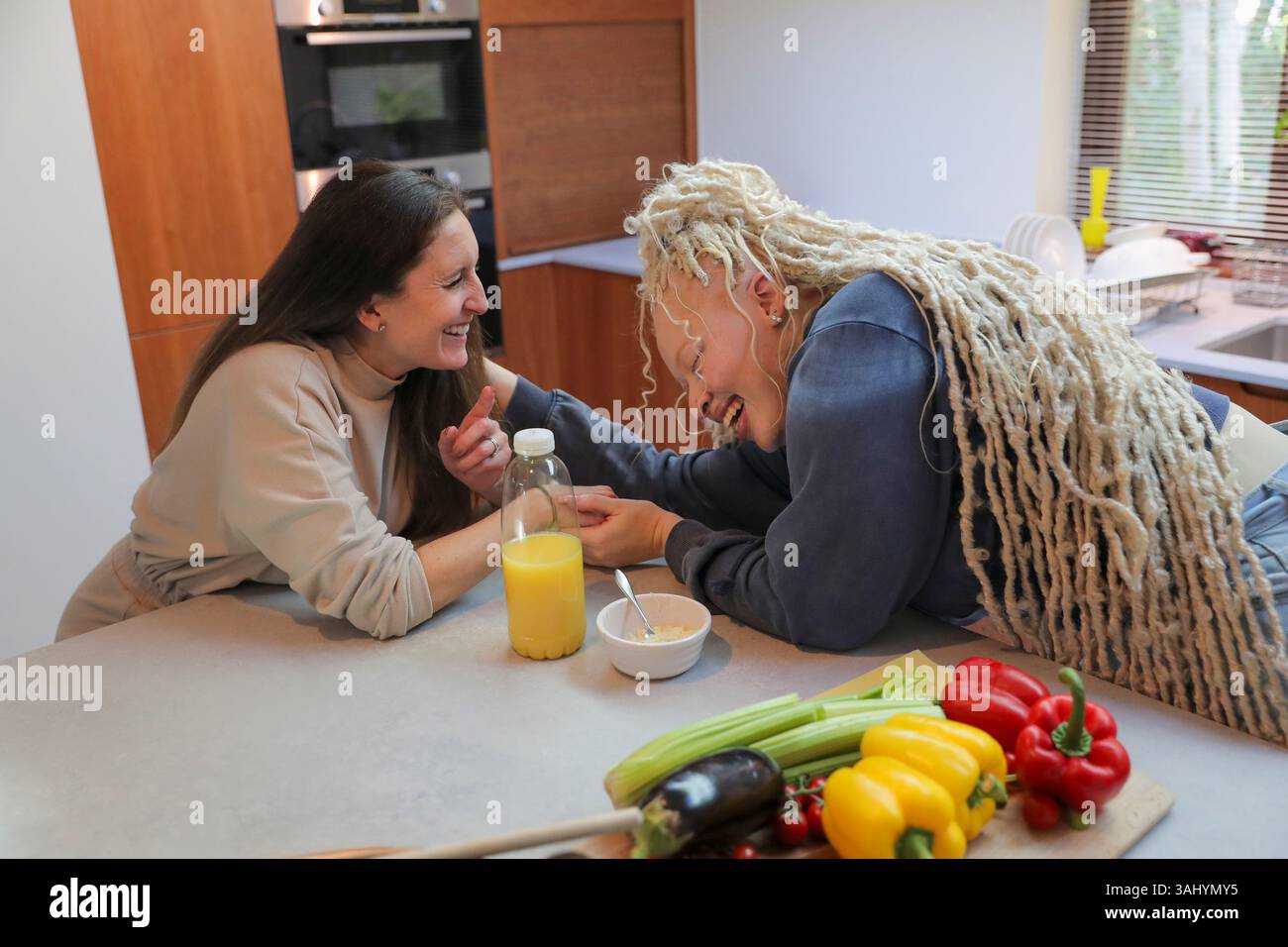 Disabled friends laughing in kitchen Stock Photo - Alamy