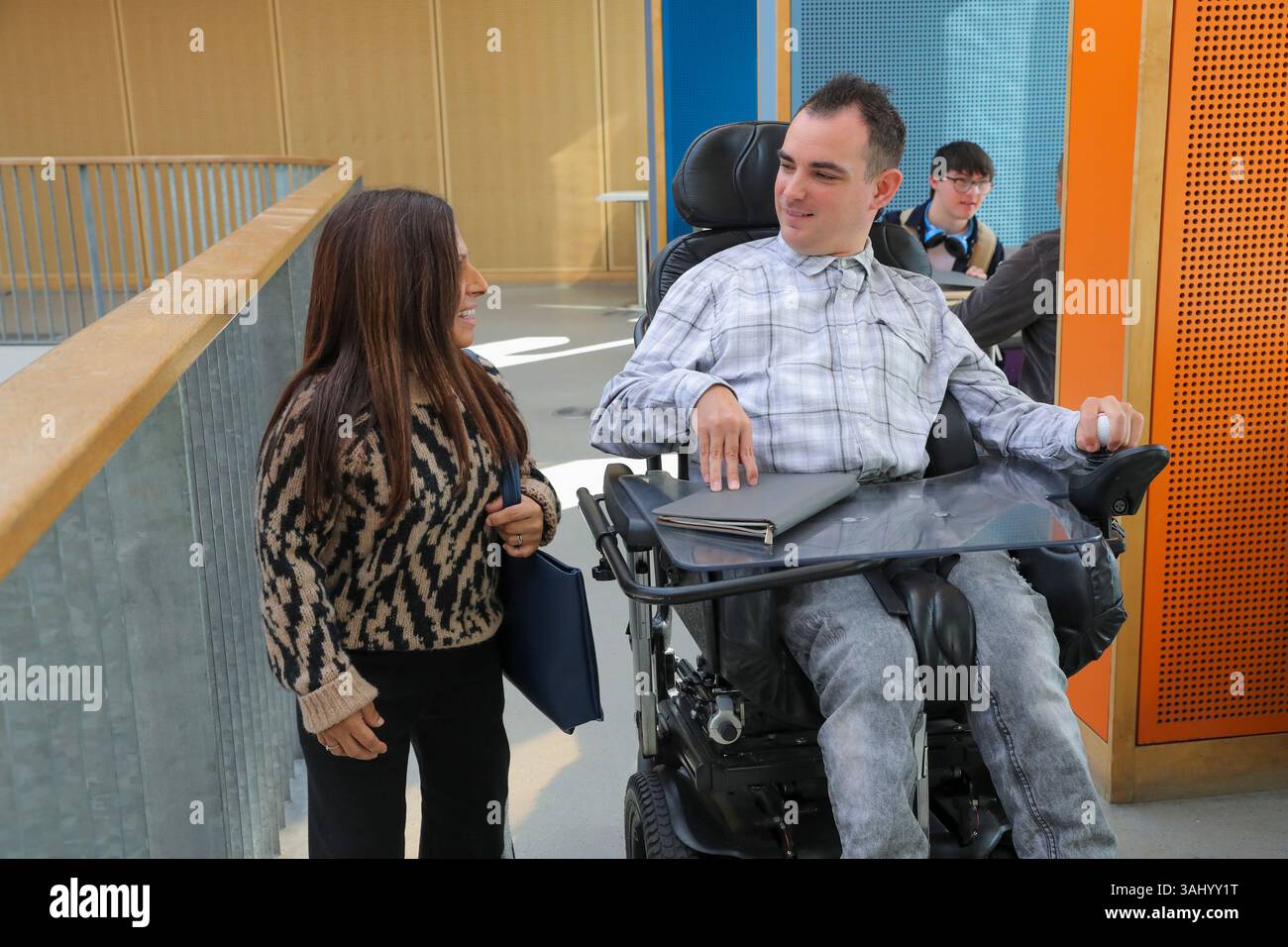 Teacher and student with disabilities at university Stock Photo - Alamy
