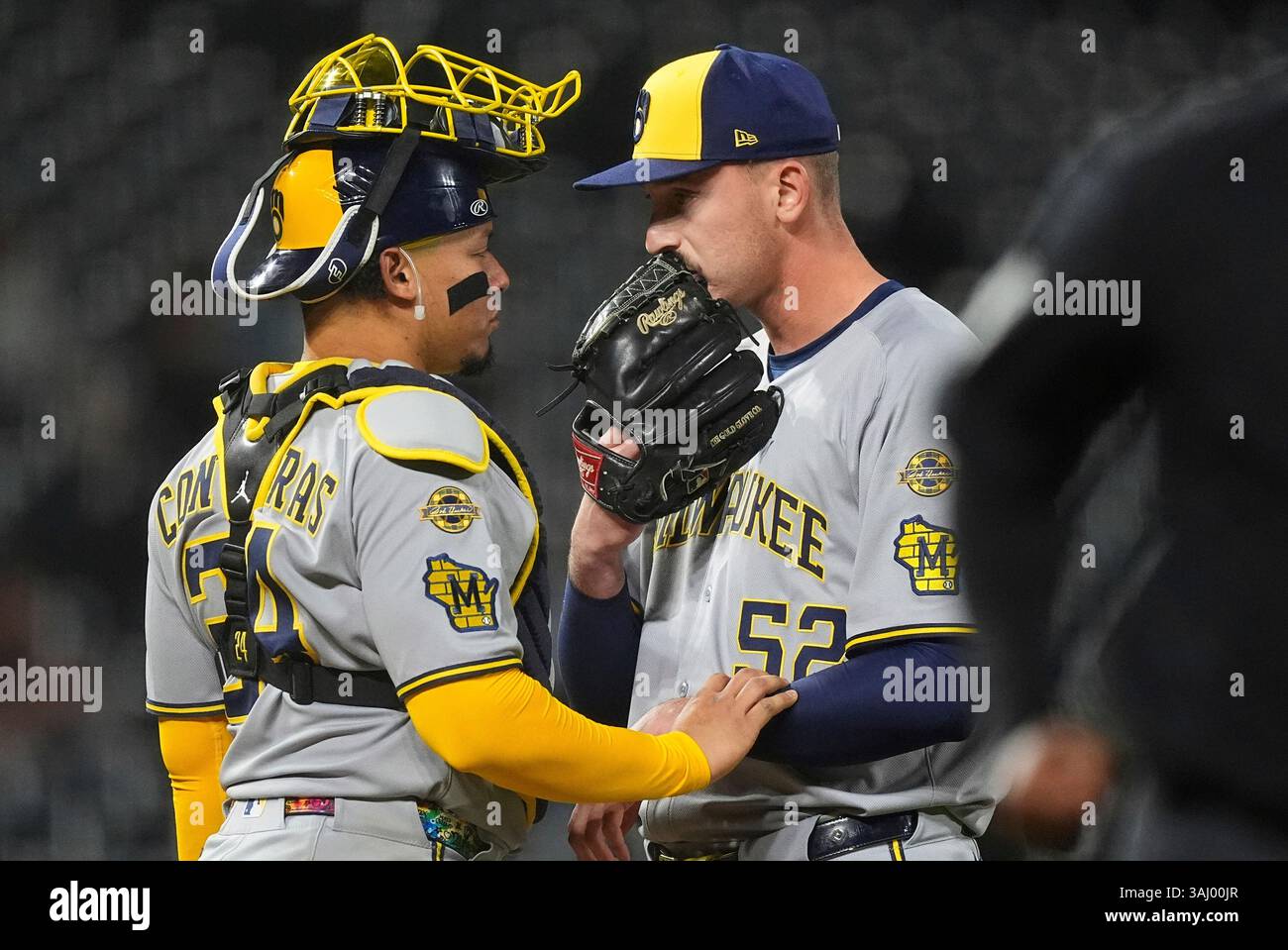 Milwaukee Brewers catcher William Contreras (24) and relief pitcher ...