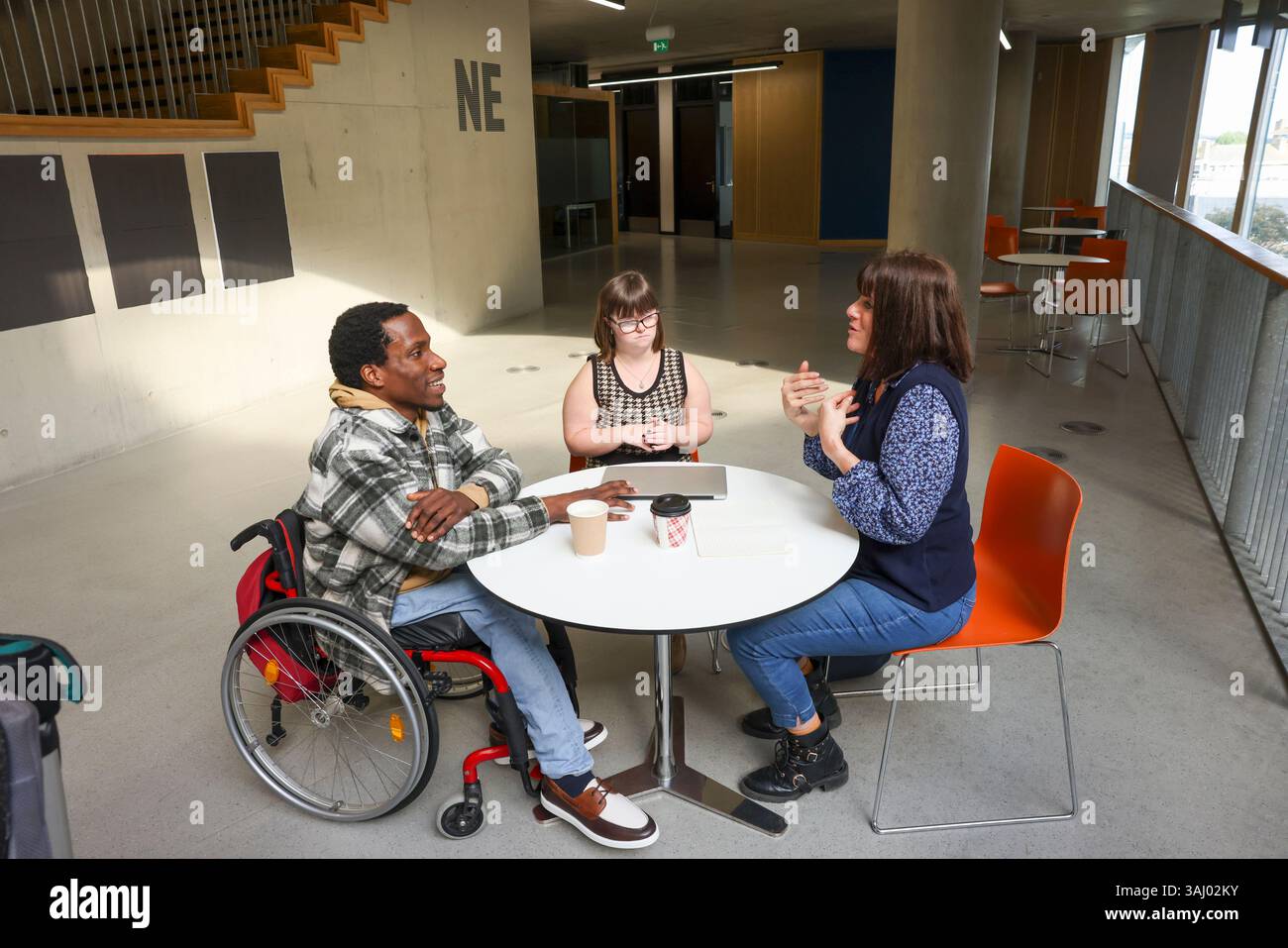Disabled coworkers at table in office Stock Photo - Alamy