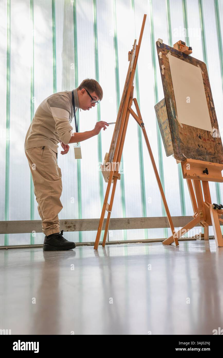 Man with Down Syndrome painting Stock Photo - Alamy