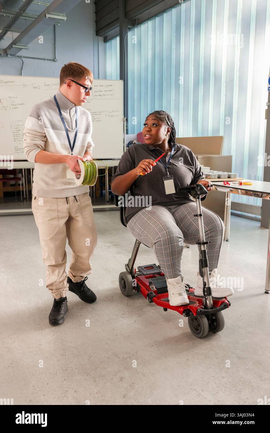 Disabled man and woman talking in workshop Stock Photo - Alamy
