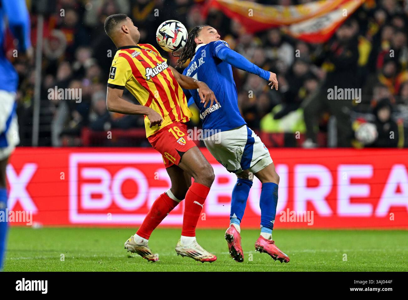 Andy Diouf (18) of Lens and Diego Moreira (7) of Strasbourg fighting ...