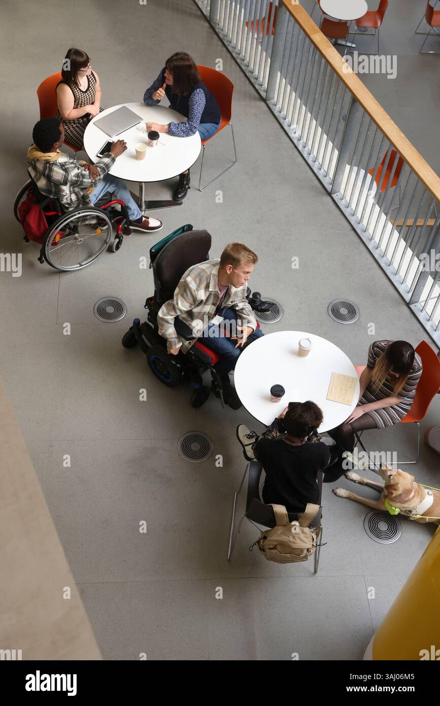 Disabled people talking at tables Stock Photo - Alamy