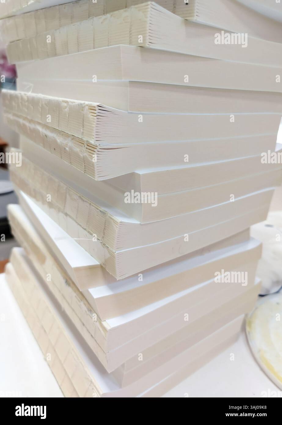 Close-up, a stack of glued book blocks prepared for binding in a ...