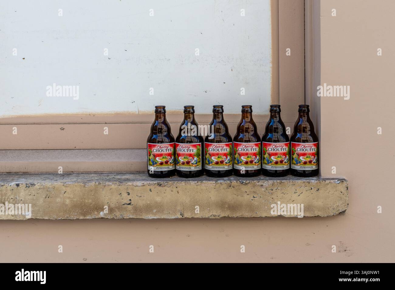 Six empty Belgian beer bottles on a window sill in Paris. Cherry ...