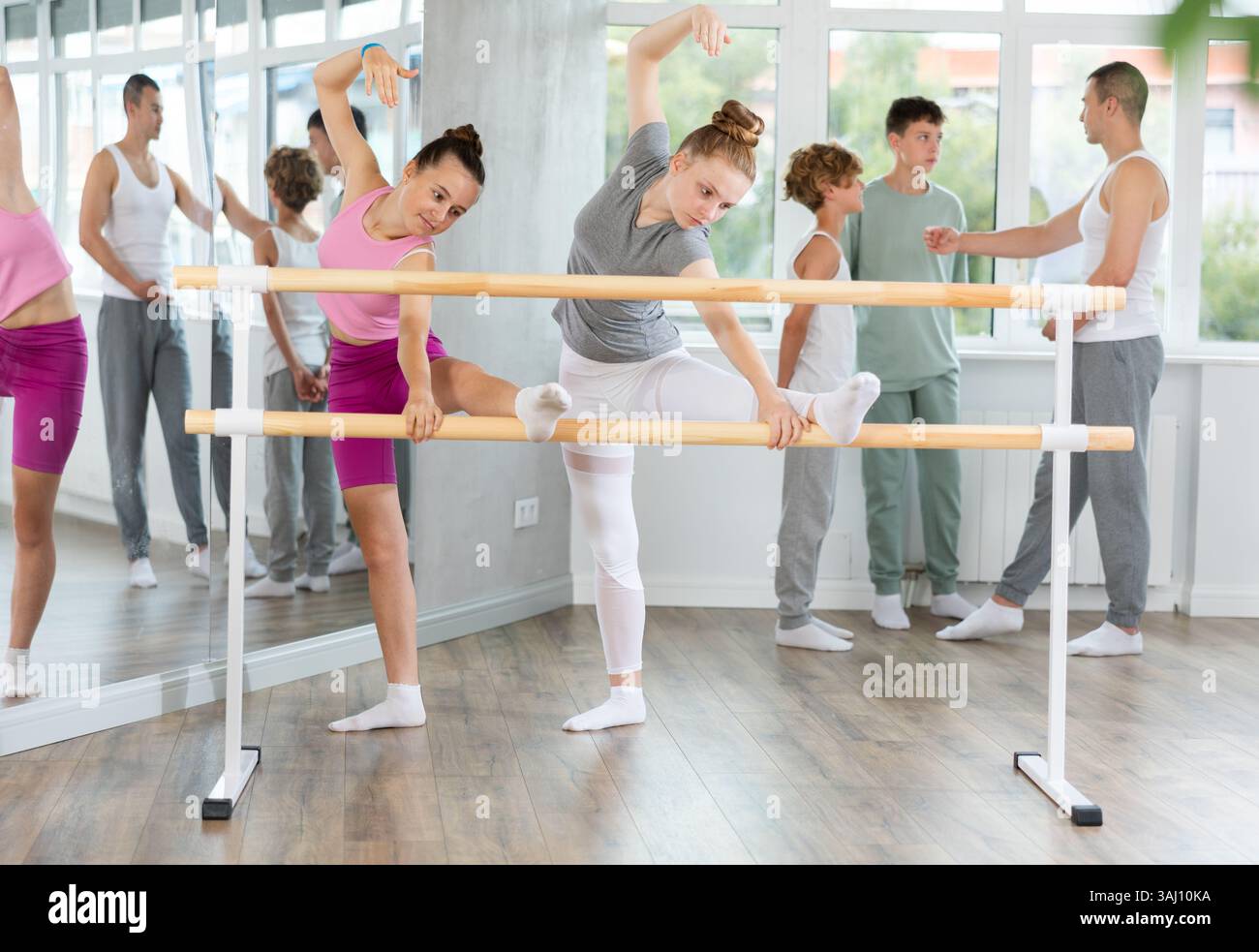 Ballet pose grand batman - girls and boys at a choreography lesson are ...