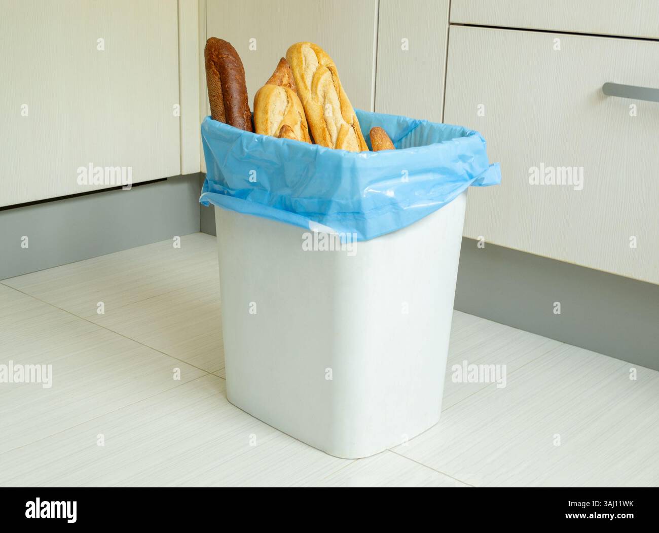 stale spoiled bread, loaves, baguettes in the organic waste bin in the ...