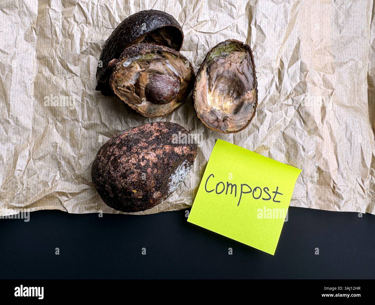 Spoile, rotten, bad ugly avocado with fungal mould with compost sticker ...