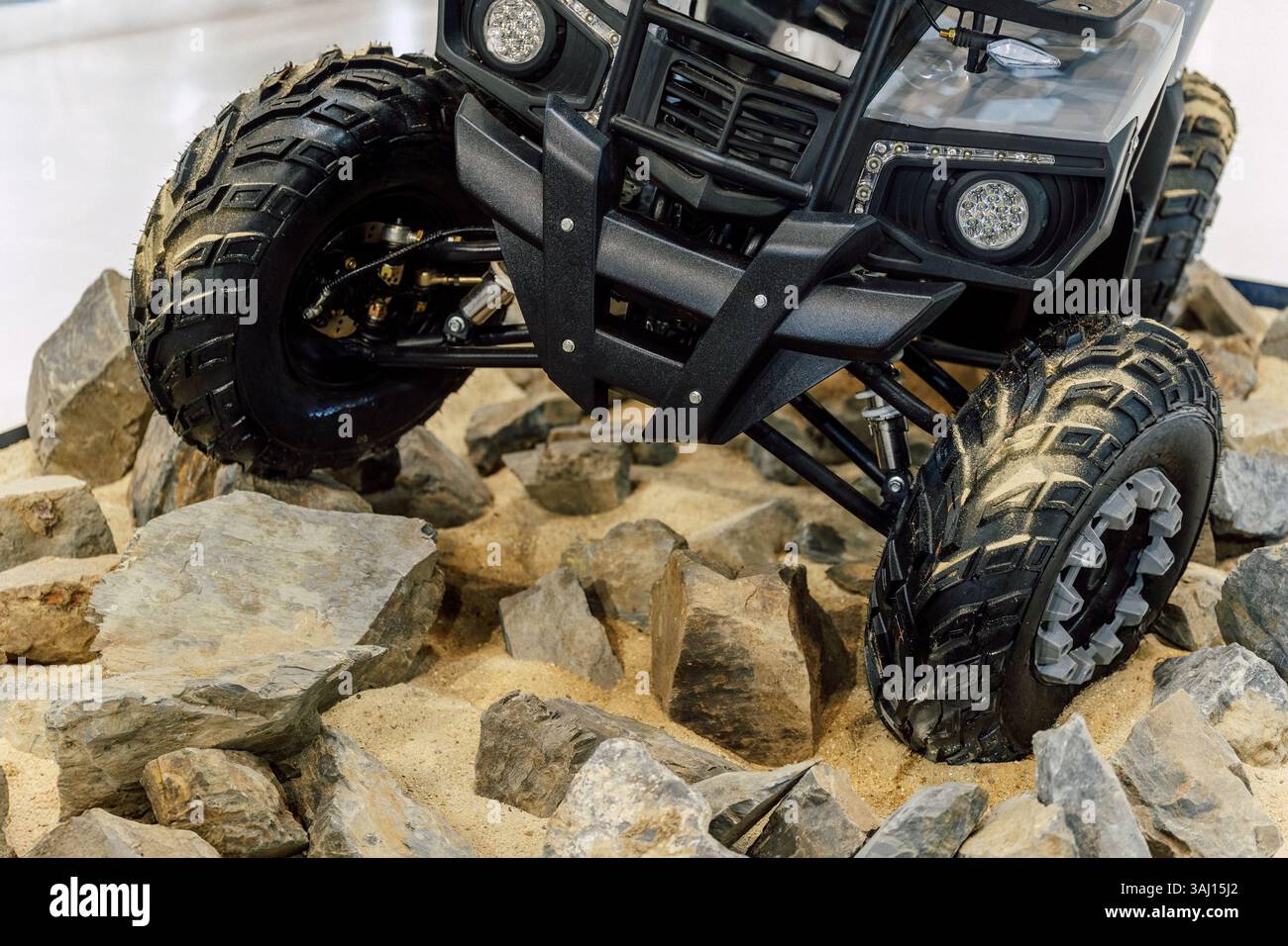 off-road quad bike wheel on a pile of rocks. off-road studded tire on ...